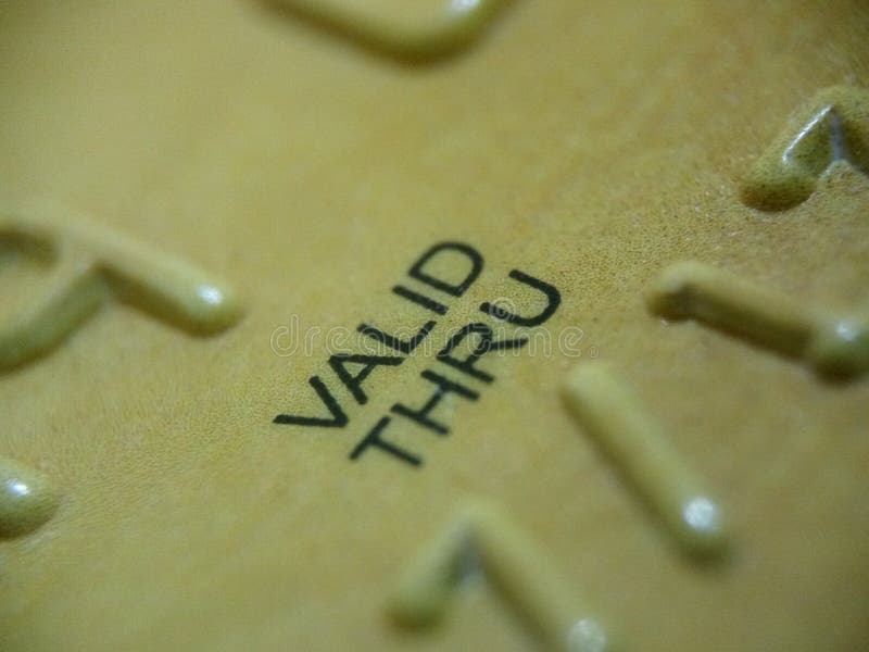VALID THRU Written on a Surface with Parts of Embossed Numbers Stock ...