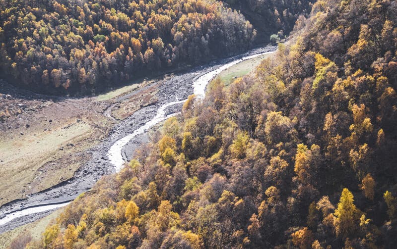 A Valley in Autumn in the Mountains with Yellowed Forest on the Slopes ...