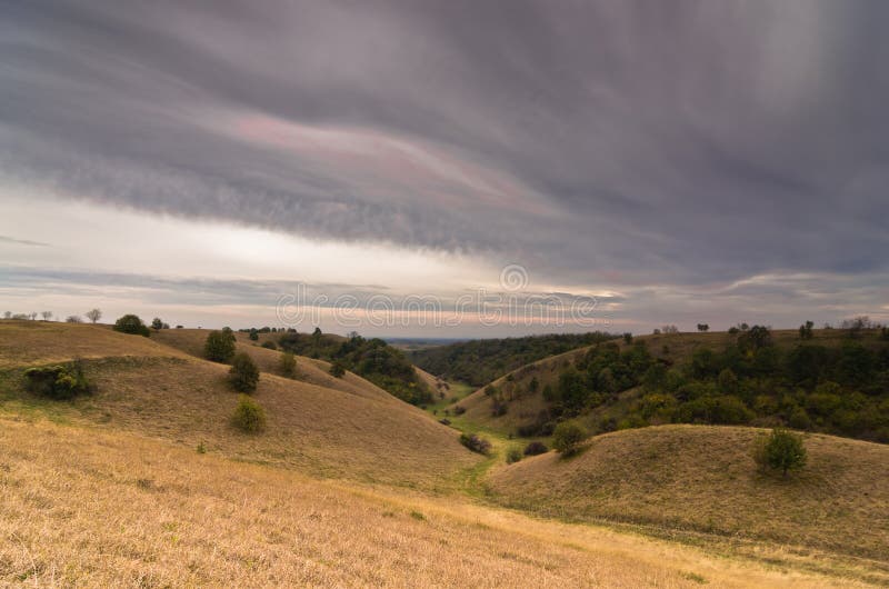 Valley between Small Hills Under Dark Clouds Stock Photo - Image of ...