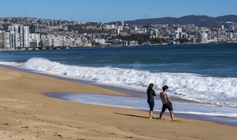 Valparaiso, Chile - 2019-07-30 - Two People Walk Along the Beach with ...