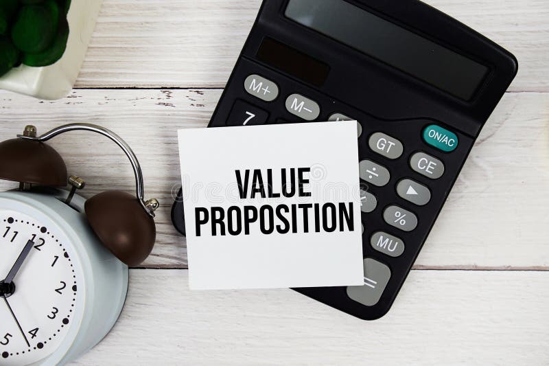 Value Proposition Text on Sticky Note with Alarm Clock and Calculator ...