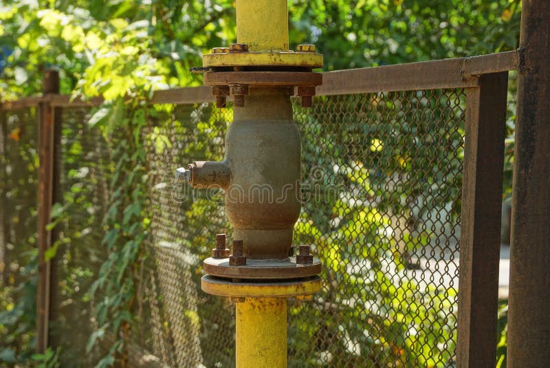 Valve on a Large Iron Pipe on Fence a Street Stock Photo - Image of ...
