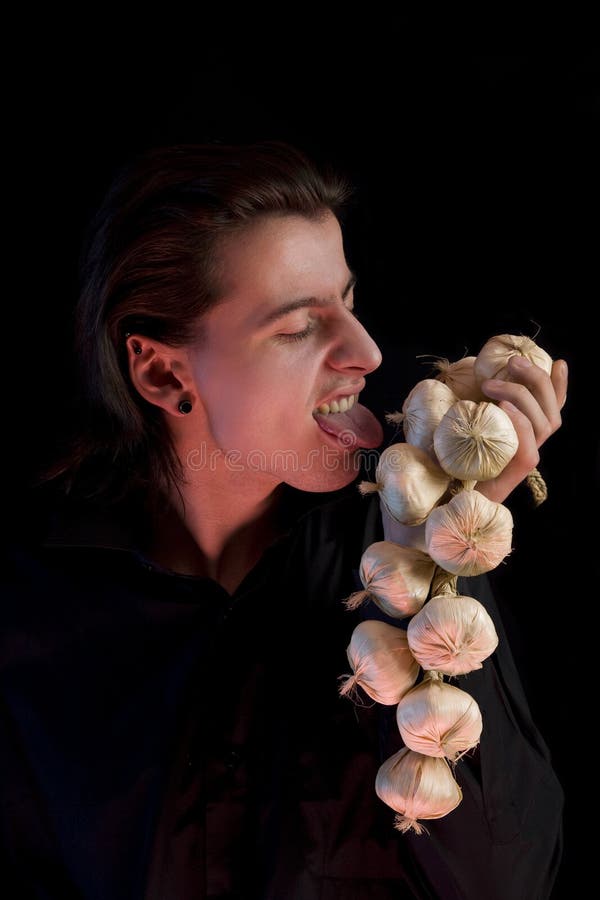Vampire with Scary Eyes is Licking Garlic Stock Image - Image of ...