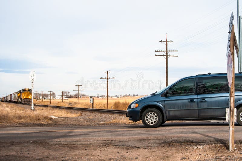 A Van Crossing the Tracks in Front of a Train Stock Image - Image of ...