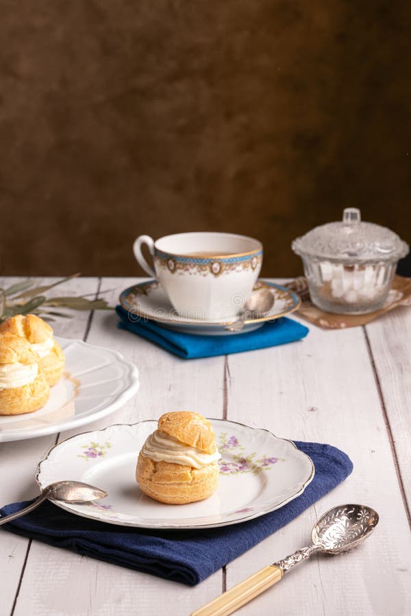 Vanilla Cream Puffs on a Wooden Table Stock Photo - Image of powdered ...