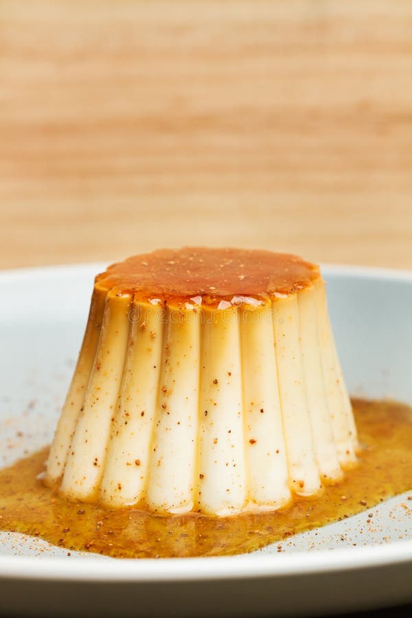 A vanilla flan on a dish stock photo. Image of gourmet - 114796574