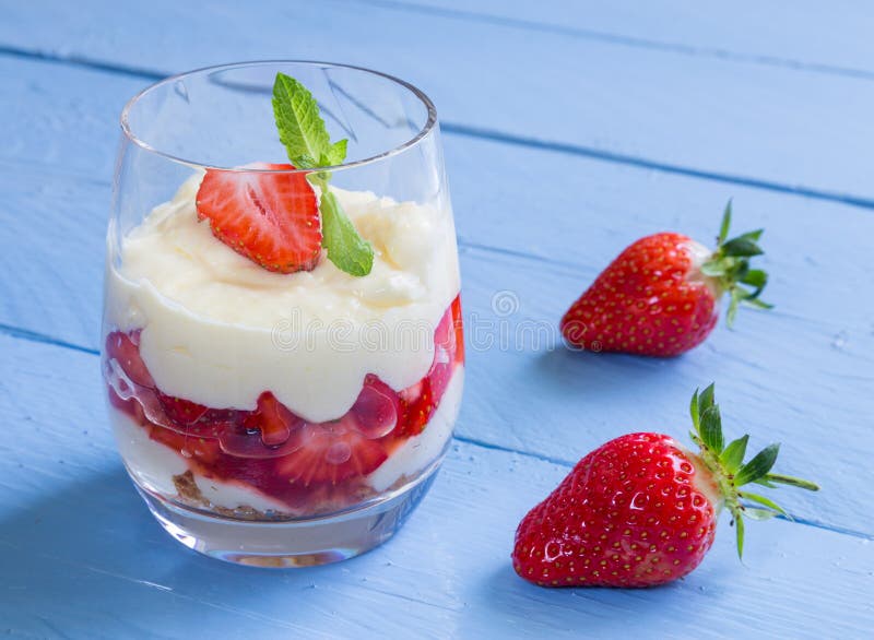 Vanilla Pudding with Tipsy Strawberries on Wood Stock Photo - Image of ...