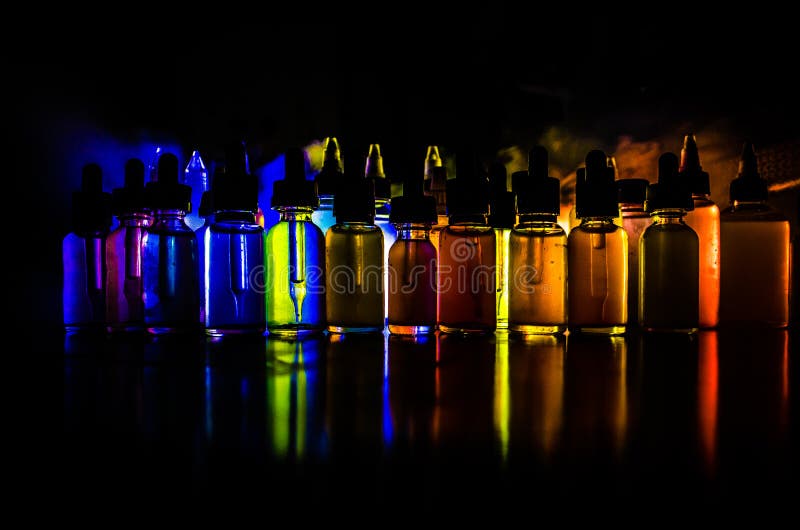 Vape Concept. Smoke Clouds and Vape Liquid Bottles on Dark Background ...