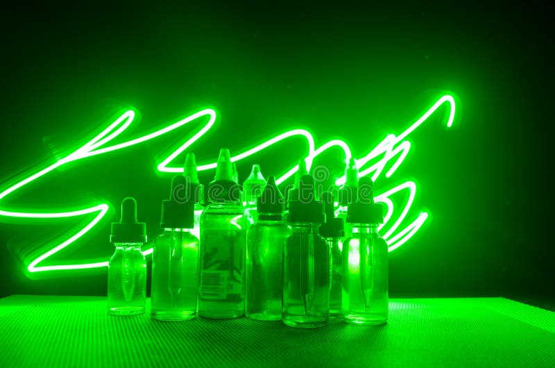 Vape Concept. Smoke Clouds and Vape Liquid Bottles on Dark Background ...