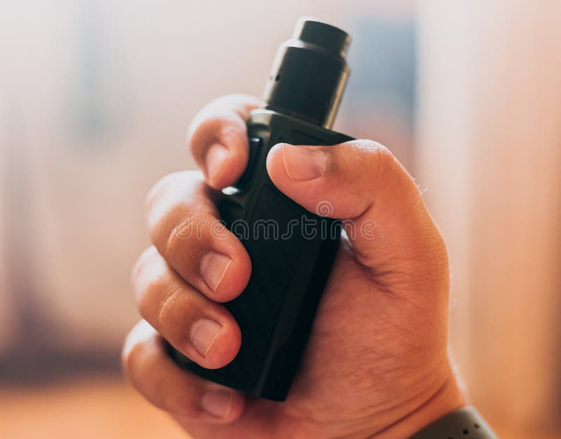 Vape device in mans hand stock photo. Image of flavour - 97918102