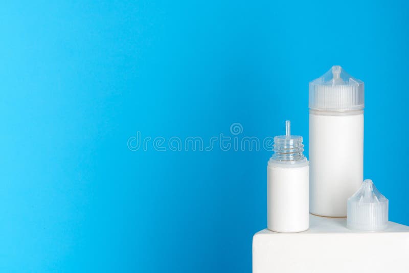 Vape Liquid Dripping Bottles Against Blue Background Stock Photo ...