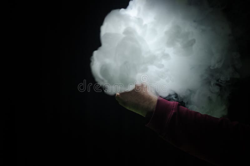 Vaping Man Holding A Mod A Cloud Of Vapor Black Background Stock