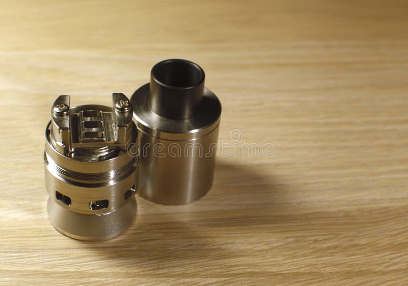 Vaping Rebuildable Dripping Atomizer RDA on Wooden Surface with Copy ...