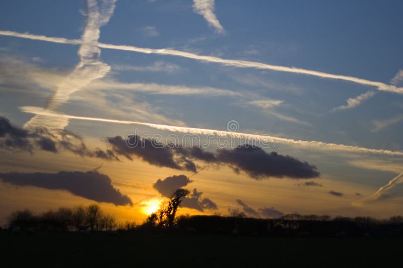 Vapor trails and sunset stock photo. Image of aircraft - 642444