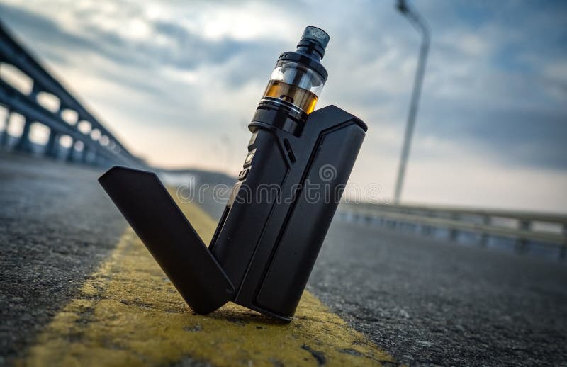 Vaporizer on the Background of the Road and Clouds Stock Photo - Image ...