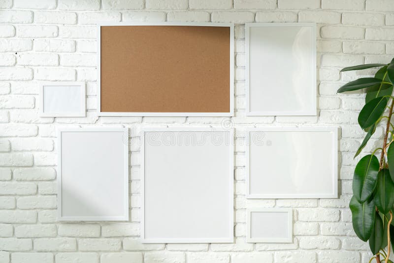 Varied Sized Photo Frames Displayed on a White Brick Wall Stock Image ...