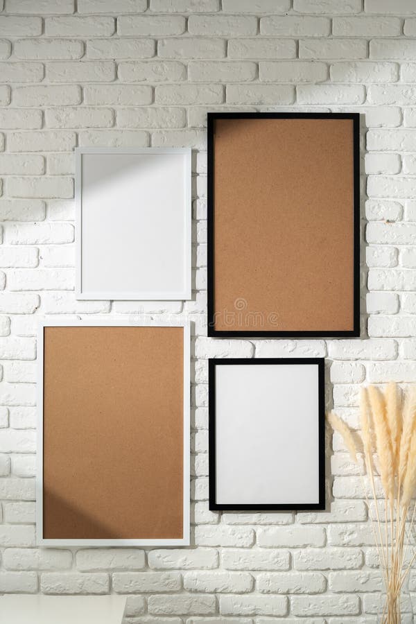 Varied Sized Photo Frames Displayed on a White Brick Wall Stock Image ...