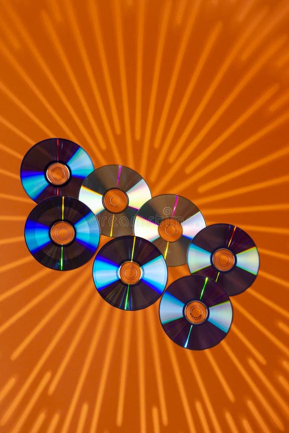 Variety of Arranged CD Disks or DVD Disks on Orange Background with ...