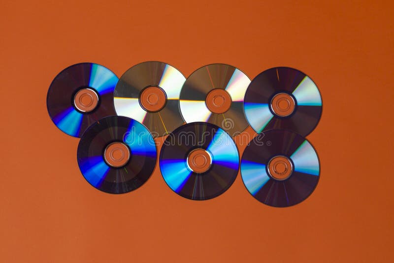 Variety of Arranged CD Disks or DVD Disks on Orange Background Stock ...
