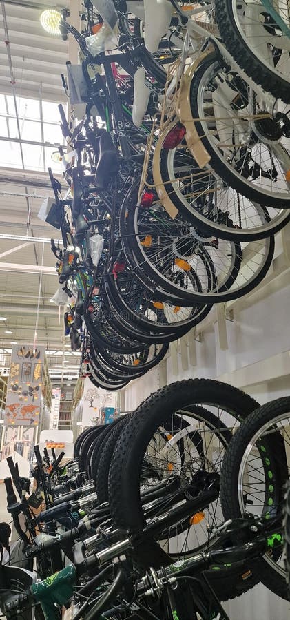 A Variety of Bikes Hang in Rows Inside a Modern Bicycle Store Interior ...