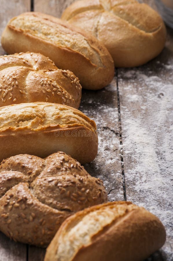 Variety of Bread Loaves on a White Wooden Table. Stock Image - Image of ...