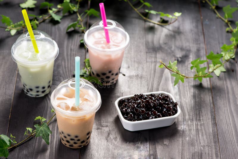 Variety of Bubble Tea in Plastic Cups with Straws on a Wooden Ta Stock ...