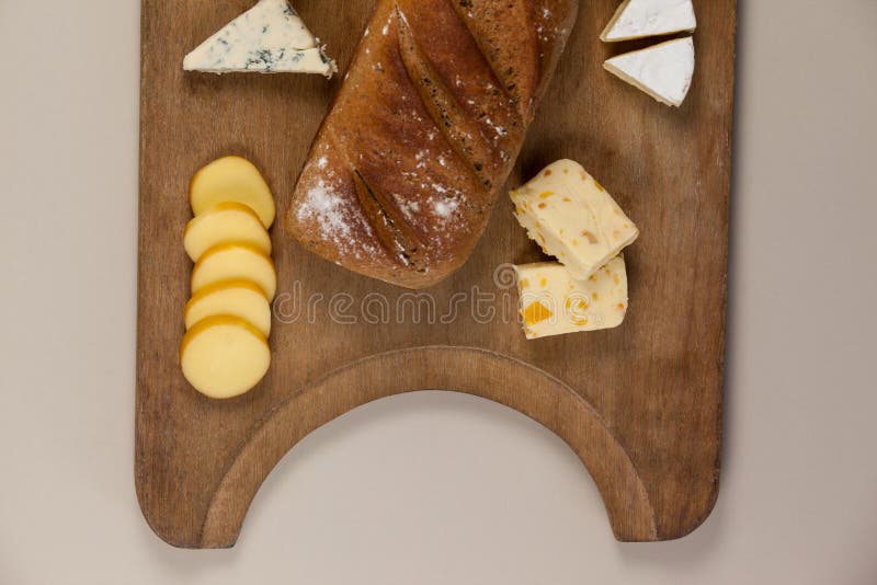 Variety of Cheese with Bread on Chopping Board Stock Photo - Image of ...