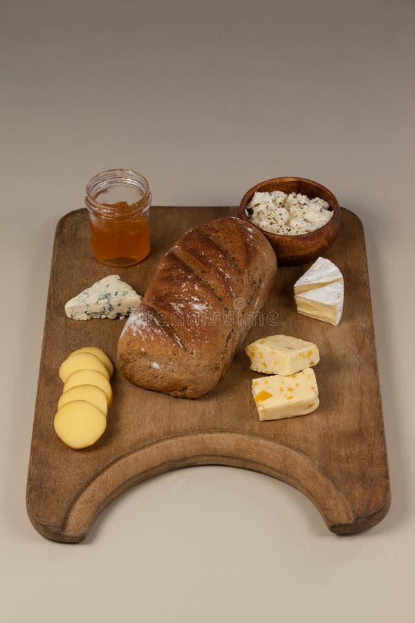 Variety of Cheese with Bread and Sauce on Chopping Board Stock Photo ...
