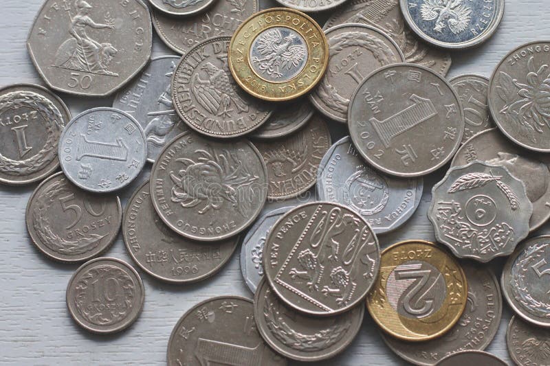 A Variety of Coins Lying on a Gray Background. Stock Photo - Image of ...