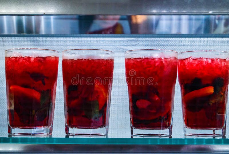 A Variety of Cold Drinks in Small Bottles with Pieces of Fruit in a Bar ...