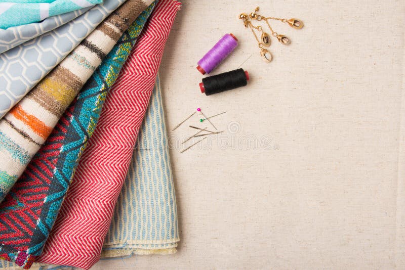 A Variety of Colourful Fabric with Assorted Sewing Pins and Thread Flat ...