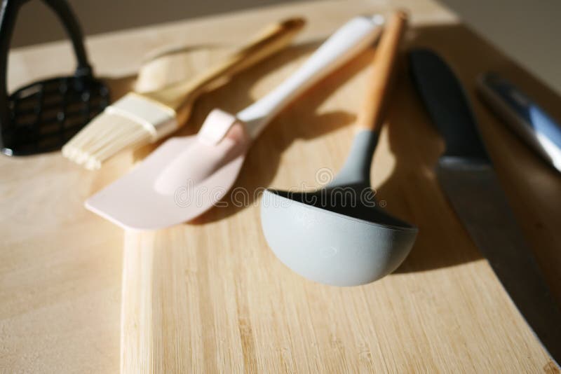 A Variety of Cooking Utensils Displayed on a Wooden Surface Table Stock ...