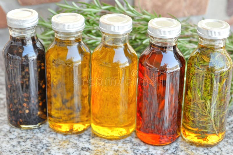 Variety of Flavored Oils in Glass Bottles with Herbs and Spices Stock ...