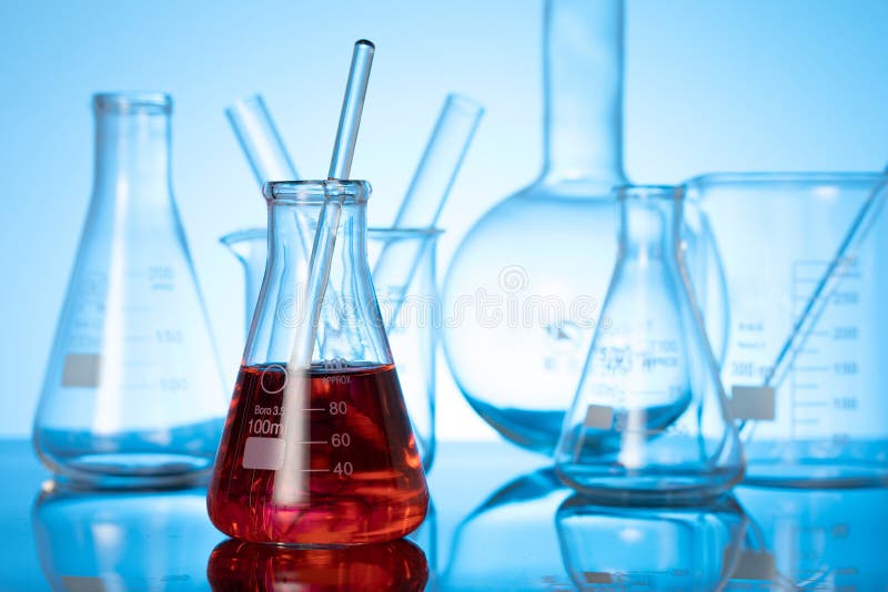 Variety of Glass Flasks and Lab Equipment with Red Liquid on a Table ...