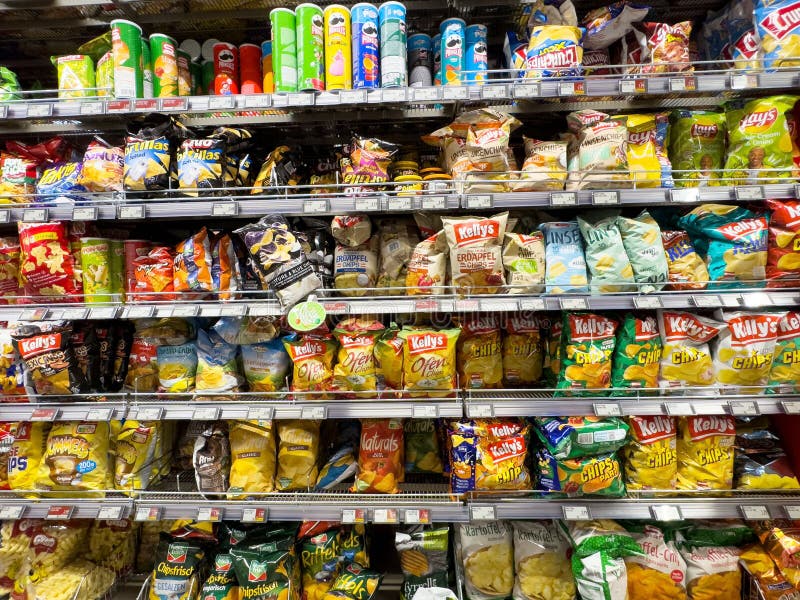 Variety of Packaged Snack Chips Displayed on Supermarket Shelves ...