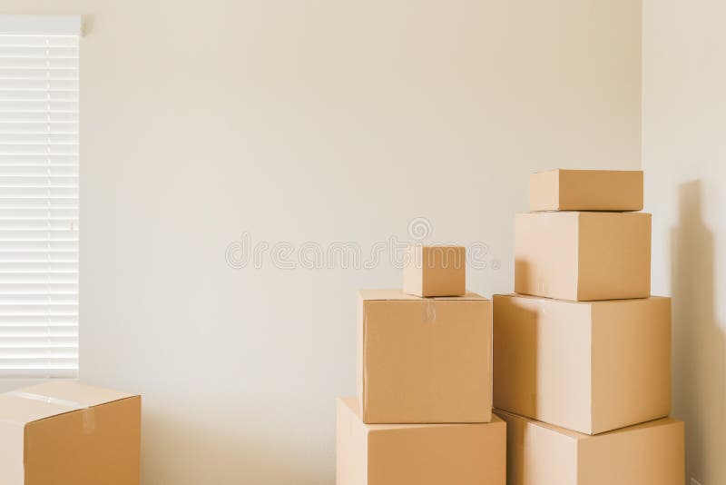 Variety of Packed Moving Boxes in Empty Room Stock Photo - Image of ...