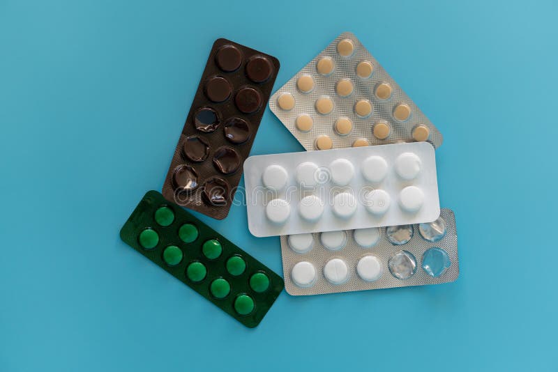 A Variety of Plastic Pills on a Blue Background Stock Image - Image of ...