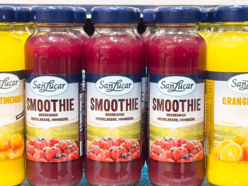 Variety of Smoothie Bottles on Display: Mixed Berry and Orange Flavors ...