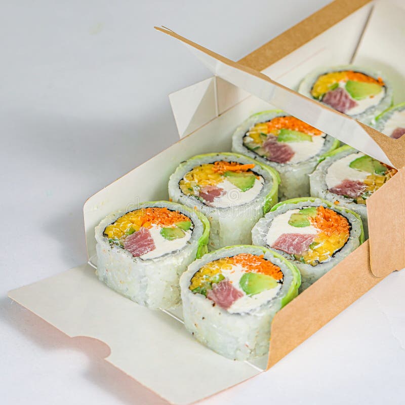 Assorted Sushi Rolls Packed in a Box on White Table Stock Photo - Image ...