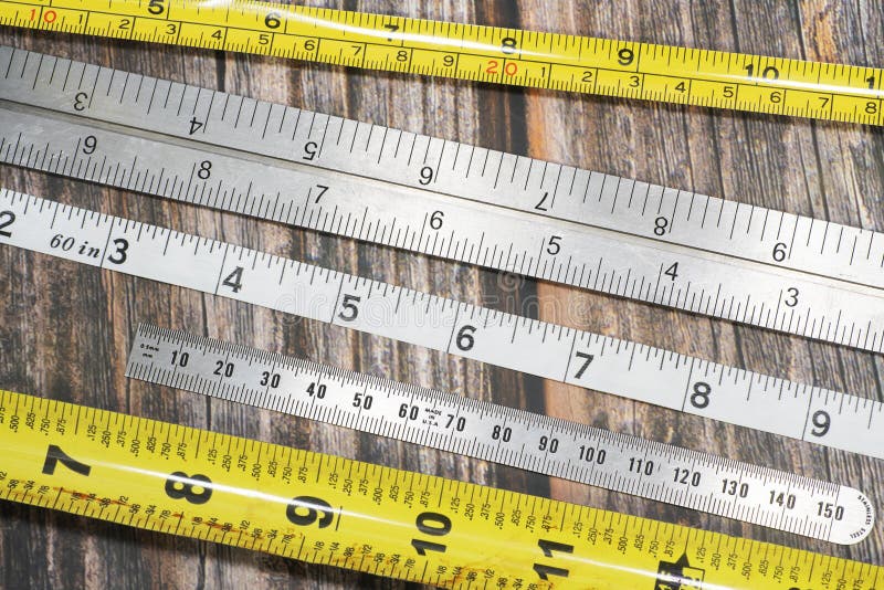 A Variety of Tape Measures on Wooden Bench Stock Photo - Image of space ...