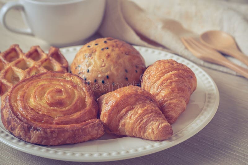 Various Baked Bread on Plate and Coffee Cup Stock Photo - Image of ...