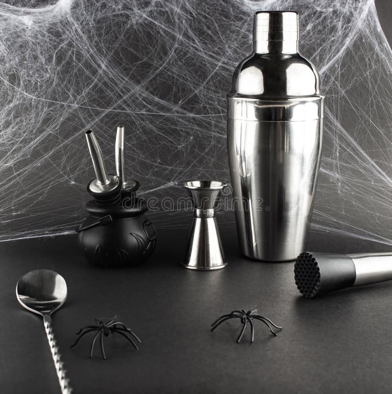 Various Bar Accessories Against the Backdrop of a Spider Web on a Black ...