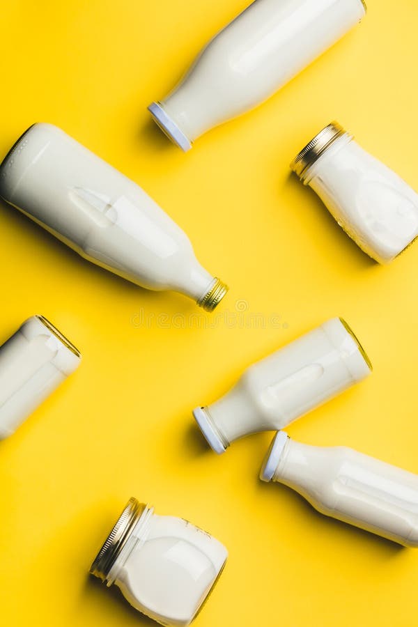 Various Bottles of Milk on Yellow Background Stock Image - Image of ...