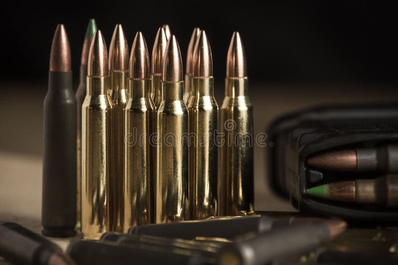 223 Caliber (5.56mm) Bullets Standing or Laying Next To a Full AR-15 ...