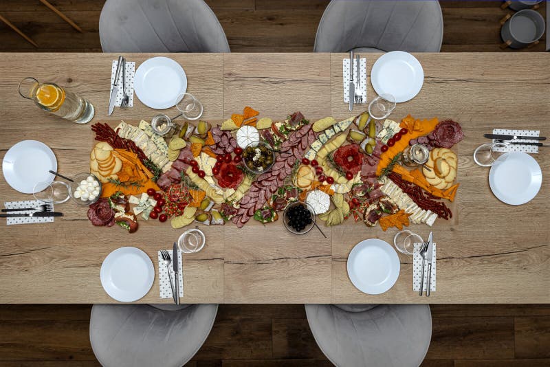 Various Cheeses and Cold Cuts Spread Out on the Table on Baking Paper ...