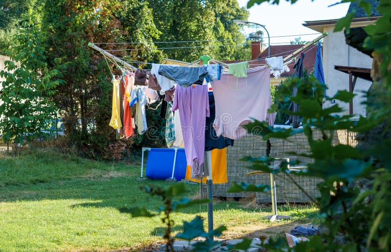 Various Clothes Drying Outside after Washing on an Umbrella Dryer Stock ...