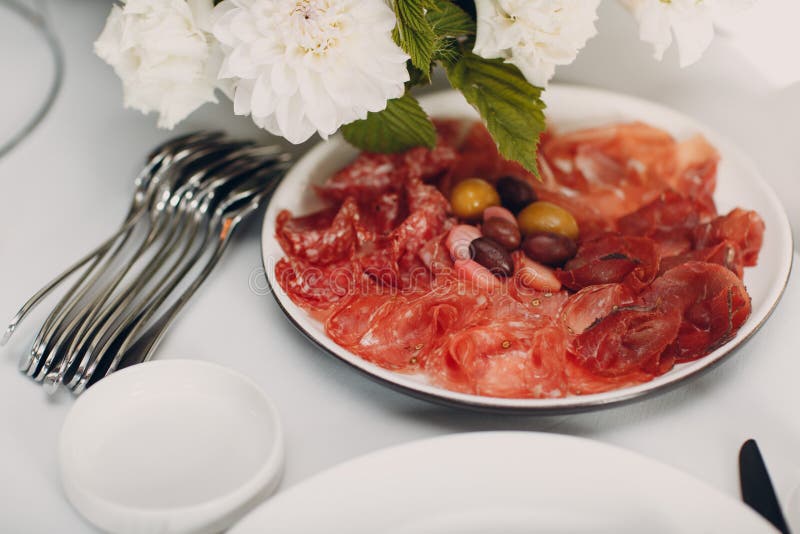 Various Cold Cuts on a Plate with White Flowers on Table Stock Image ...