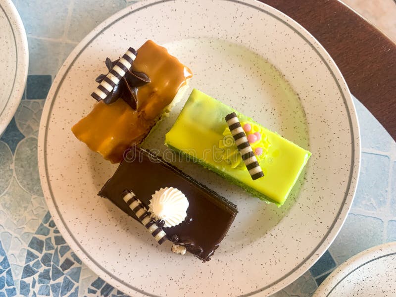 Various Colored Cakes on Plates. Sweet Desserts. Studio Photo Stock ...