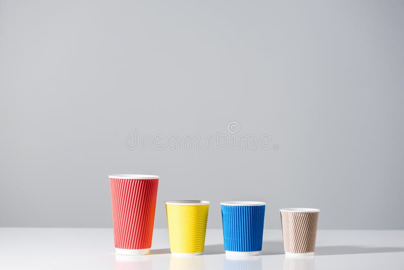 Colored Paper Cups in a Row on Grey Stock Image - Image of disposable ...