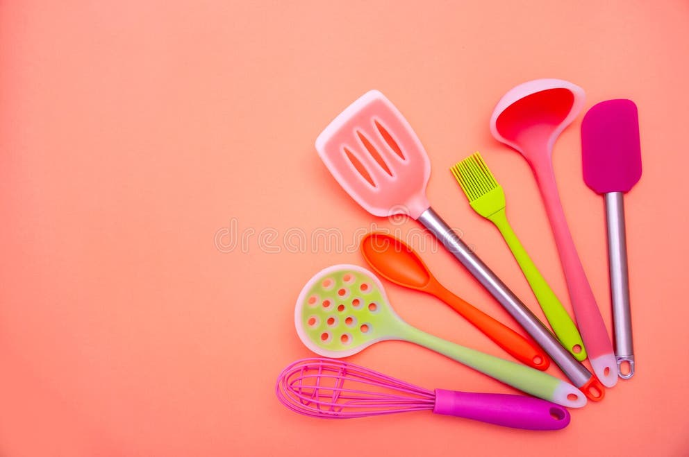 Various Colored Silicone Kitchen Utensils on Coral Background. Copy ...